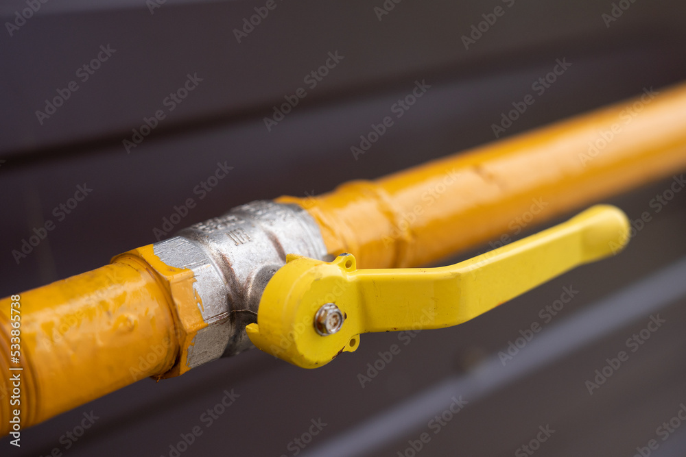 Gas pipe in the house. Yellow gas pipe. Gas pipe and valve. Home gas ...
