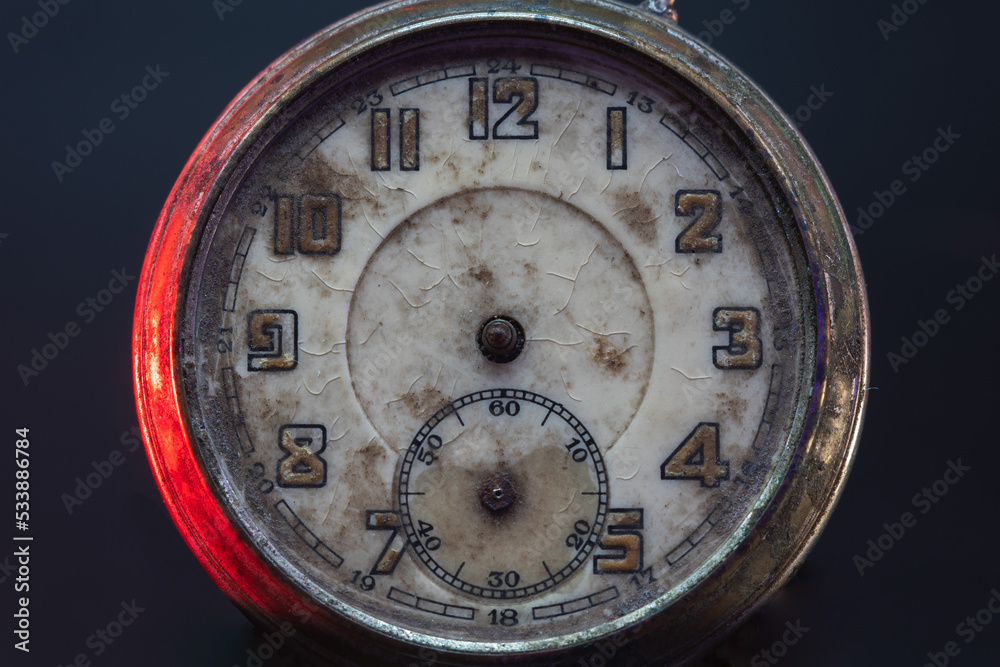 Antique silver broken pocket watch isolated on a black background, top ...