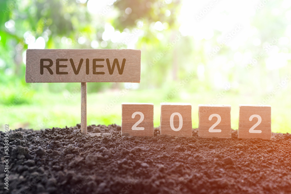 Year end 2022 review and summary concept. Wooden blocks in dark sunset ...