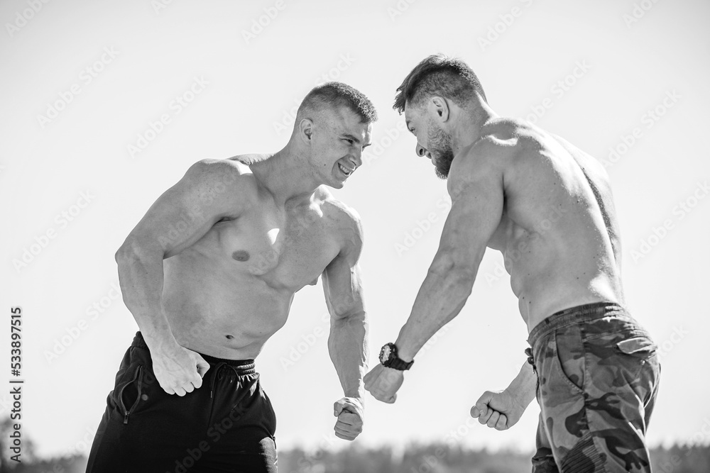 Two muscular angry man outdoor Shirtless athletic training biceps ...