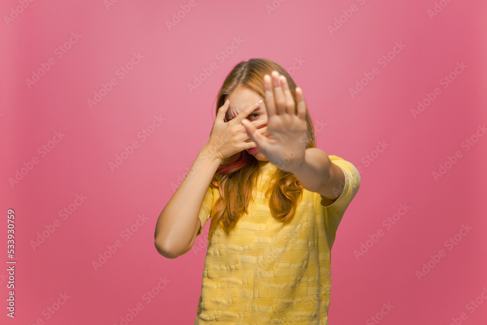 Scared shamed young girl covering eyes showing stop gesture, dont want ...