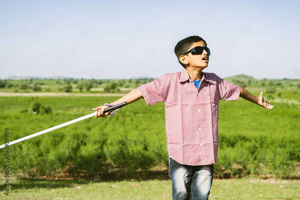 indian teeneger blind kid with eyeglasses enjoying nature and fresh air ...