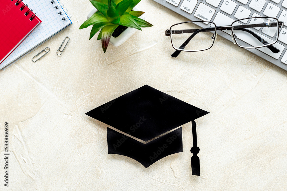 Black academic cap or graduation hat on students table, top view Stock ...