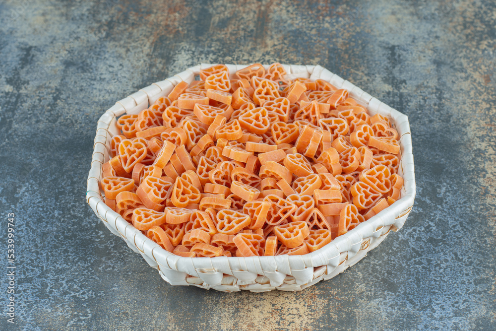 Heart shaped rotelle pasta in the bowl, on the marble background Stock ...