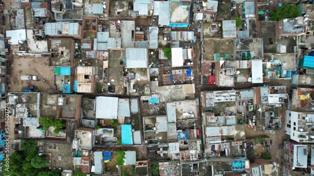 flat down aerial drone shot showing densely packed small homes with ...