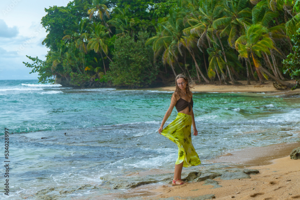 beautiful girl in yellow skirt walks on the caribbean beach in costa ...