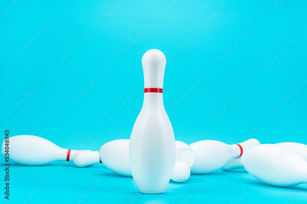 Minimalist photo of bowling pin over turquoise blue background. One ...