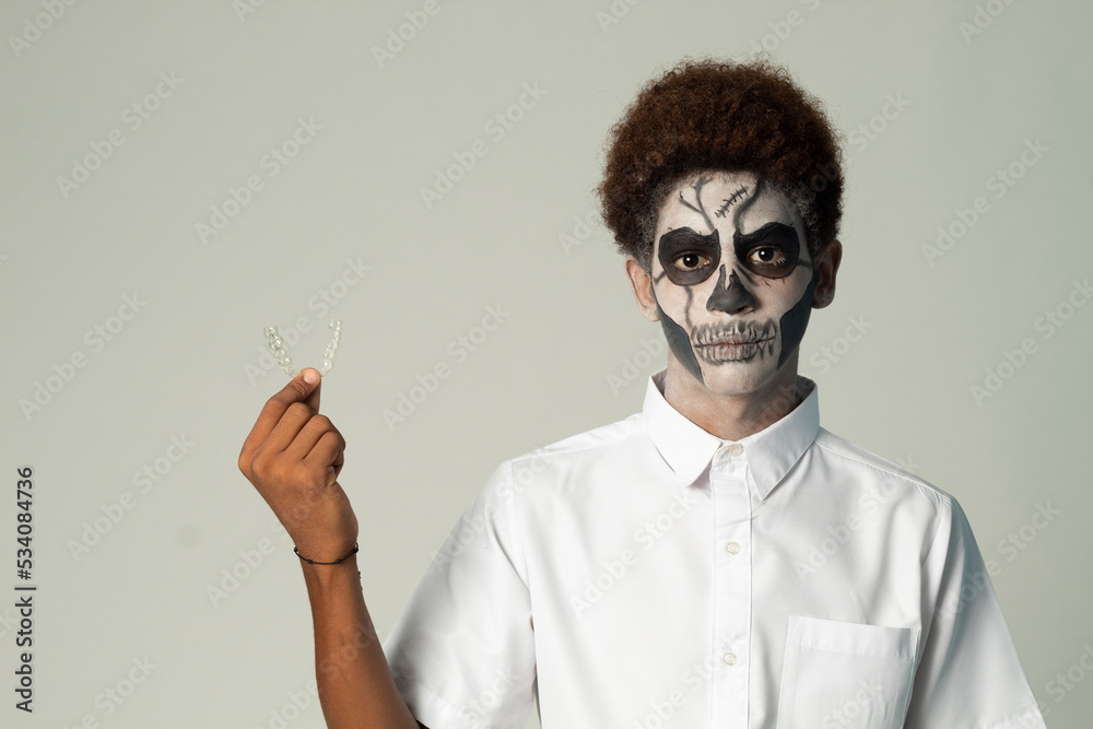 teenager painted catrin, with afro hair looking to the camera showing ...