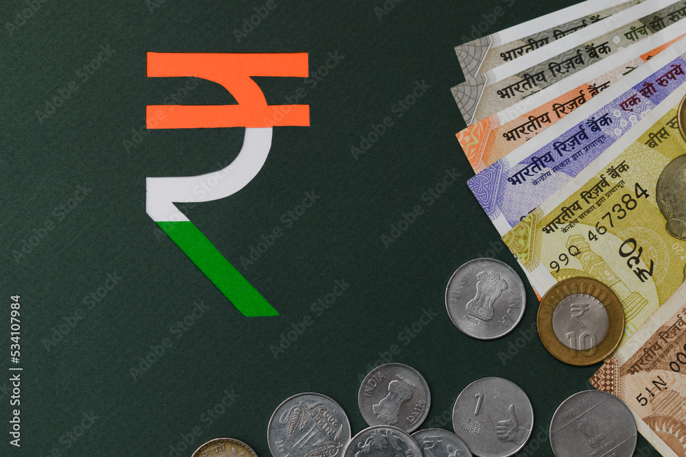 paper cut indian rupee symbol in tricolor with currency background ...
