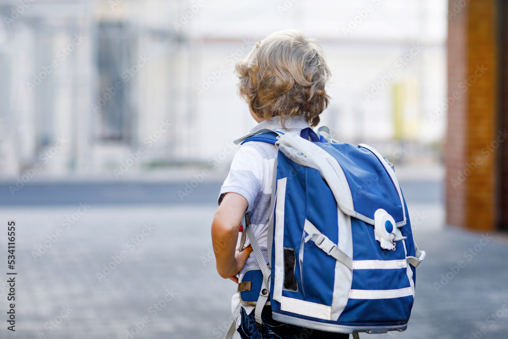 Happy little kid boy with backpack or satchel called Ranzen in German ...