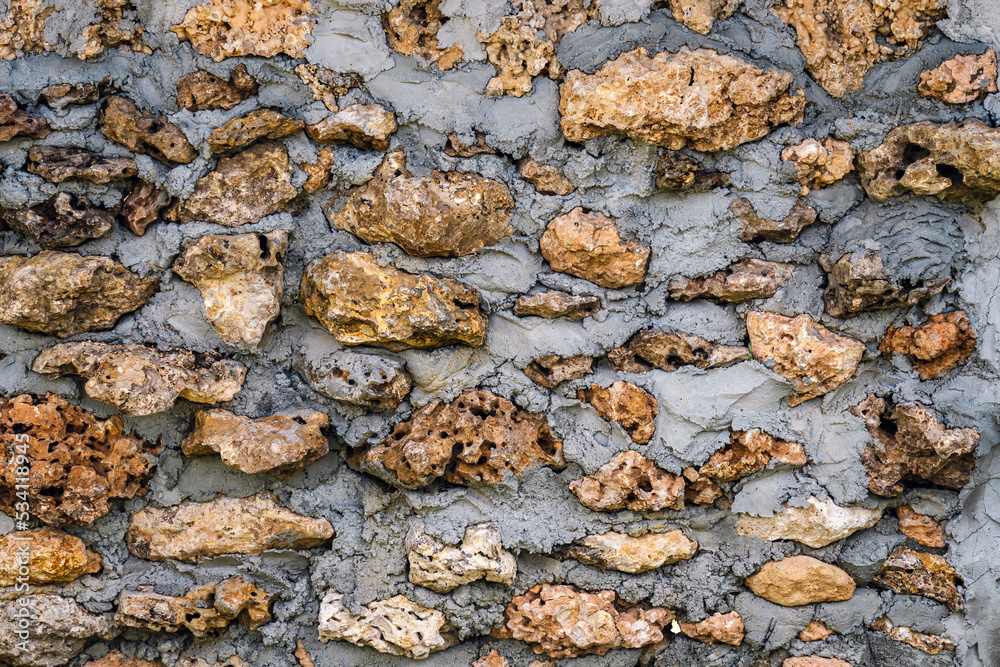 Old style wall made of rough stones with cement. Ancient grunge stones ...