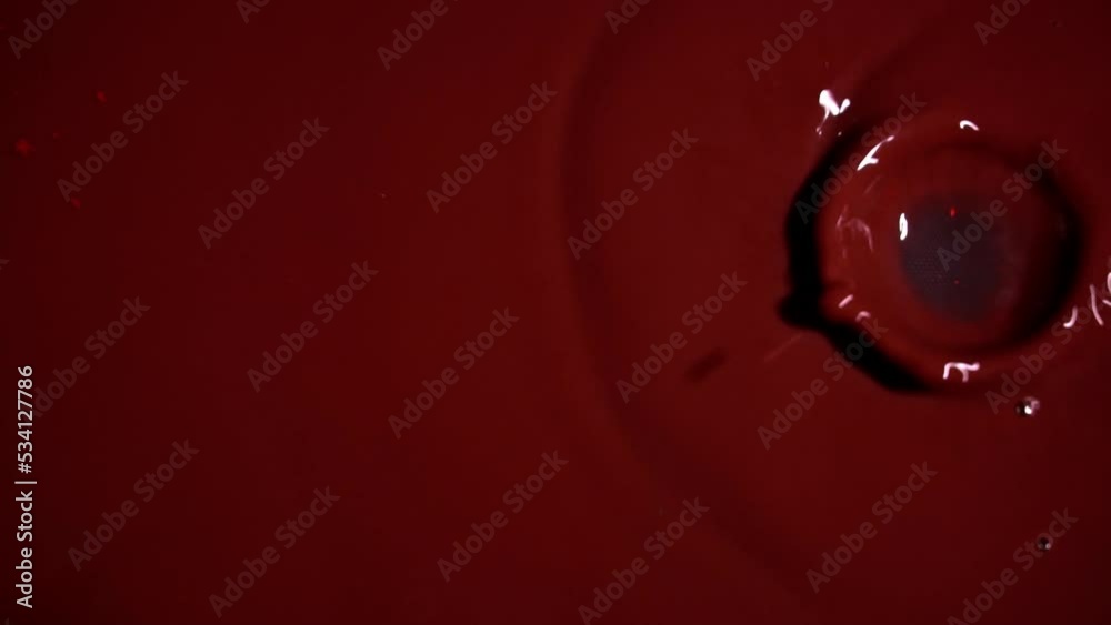 Video Stock Drops of red blood drip into a puddle of blood close-up ...