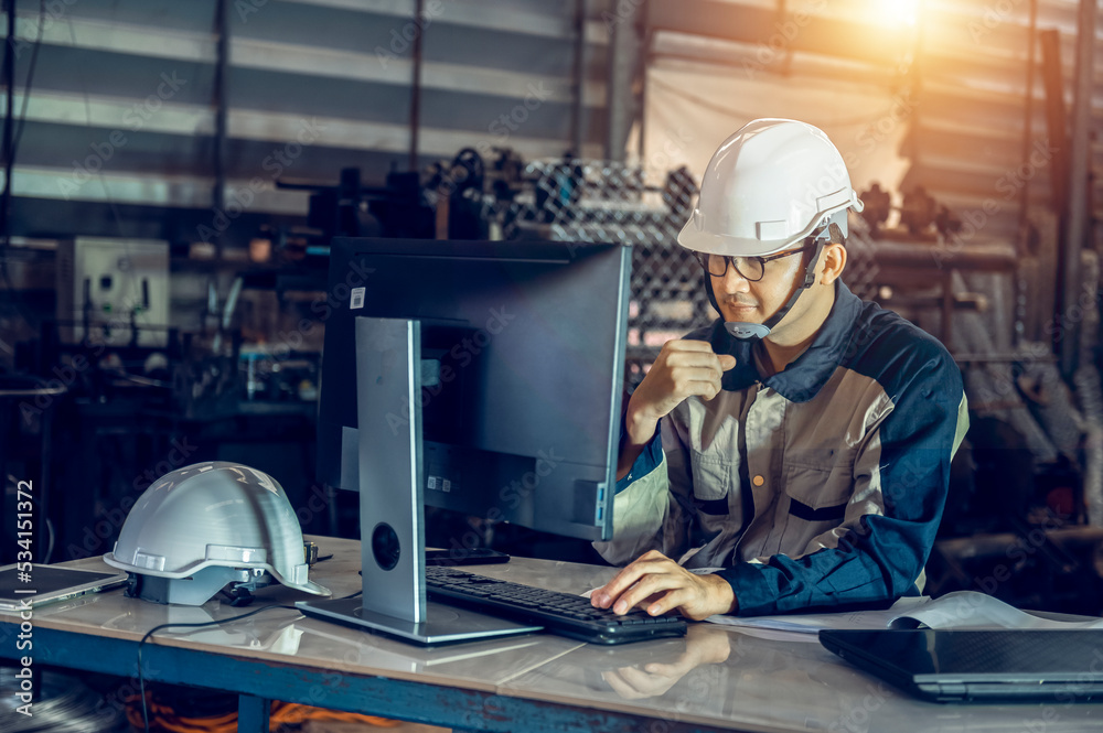 Asian project engineers who control production line facilities Use ...