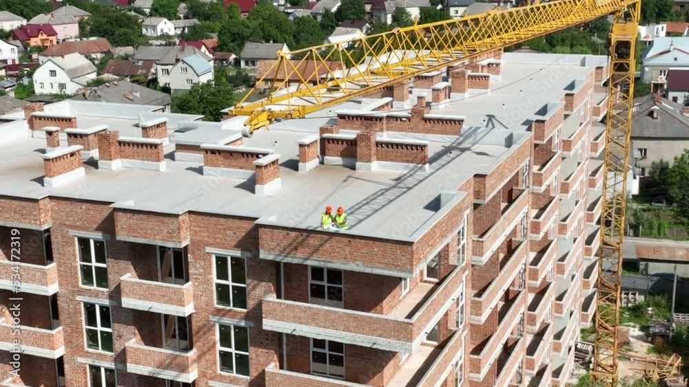 A flight over a high-rise red brick building with inset windows without ...