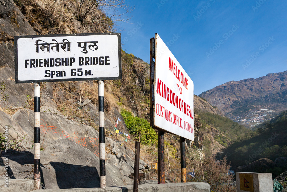 Written signs welcoming travellers across the sino-nepalese border ...