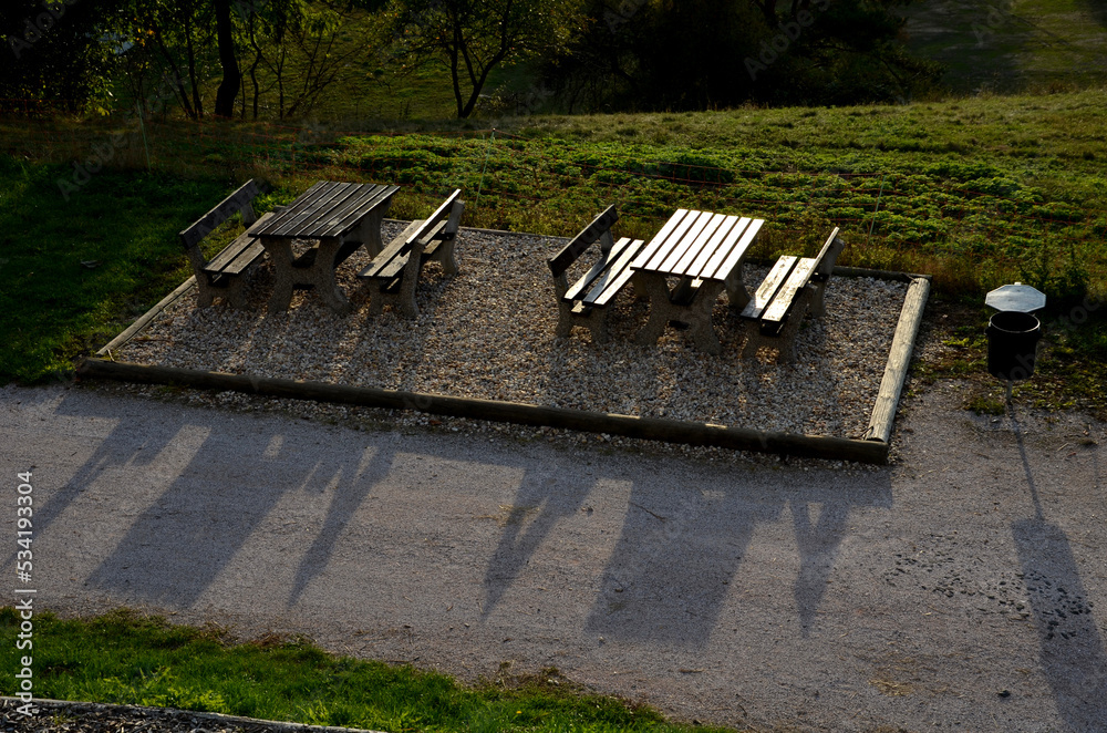 Wooden benches on the promenade in the park. massive concrete bench ...