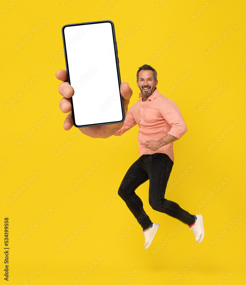 Excited middle aged man 40s jump with smartphone with white screen in ...