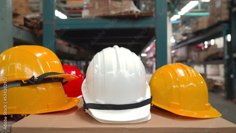 Close-up many safety helmets put on a cardboard box in warehouse store ...