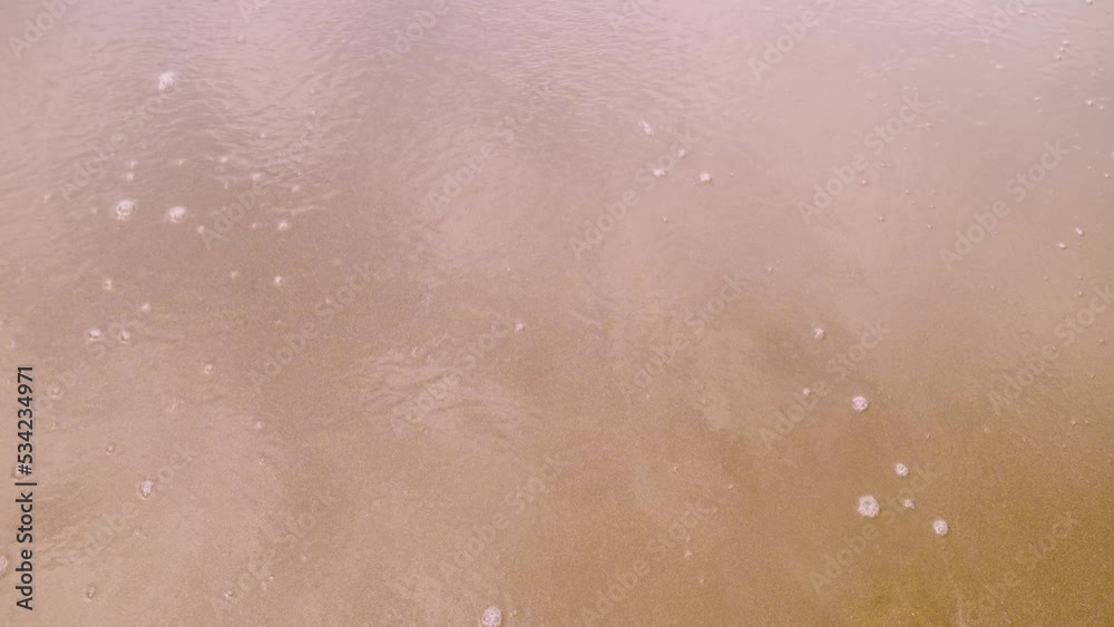 Word war is written on sand of beach wiped out of water. Words written ...