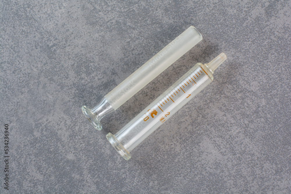 Parts of medical syringe on marble background Stock Photo | Adobe Stock