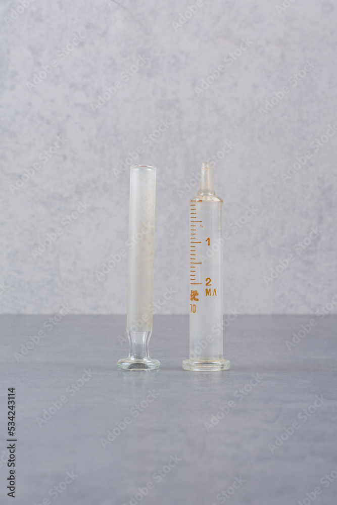 Parts of medical syringe on marble background Stock Photo | Adobe Stock