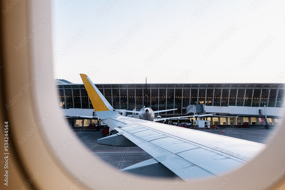 Airfield and airport behind aircraft window Stock Photo | Adobe Stock