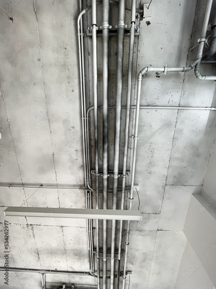 Industrial ceiling with exposed pipes part of a new modern architecture ...