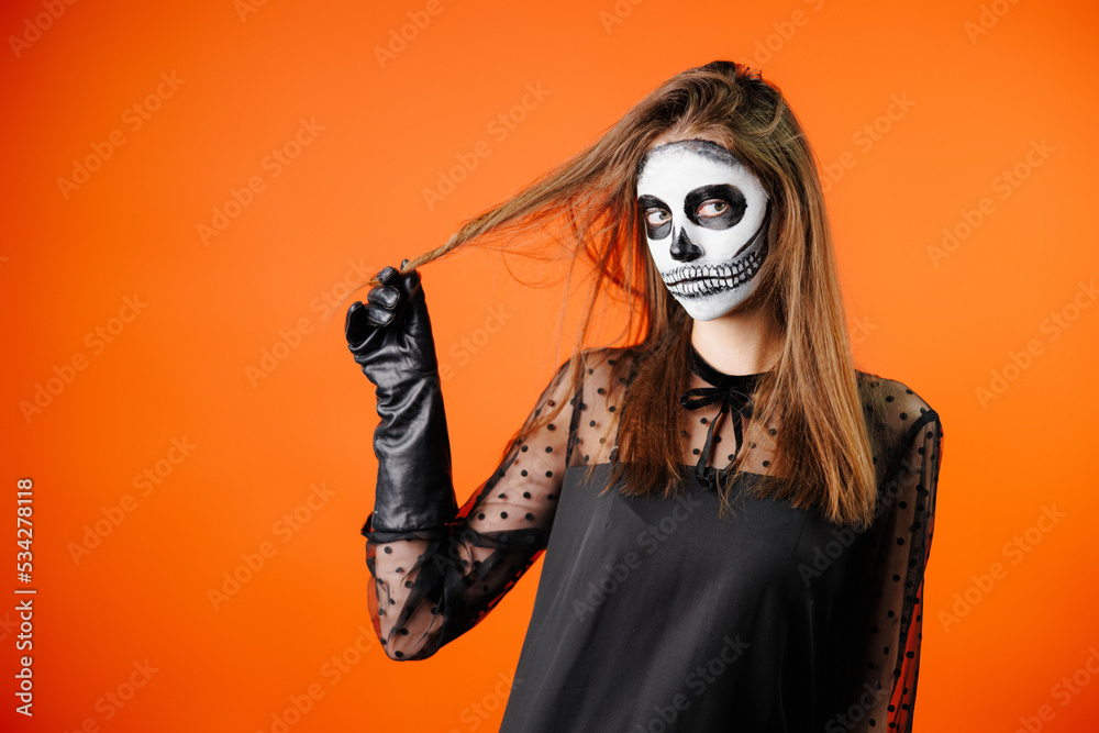 Scary female face with helloween horror grimm. Orange background. Stock ...