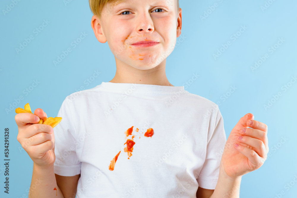 Dirty red stain of tomato sauce on clothes. A child holding French ...