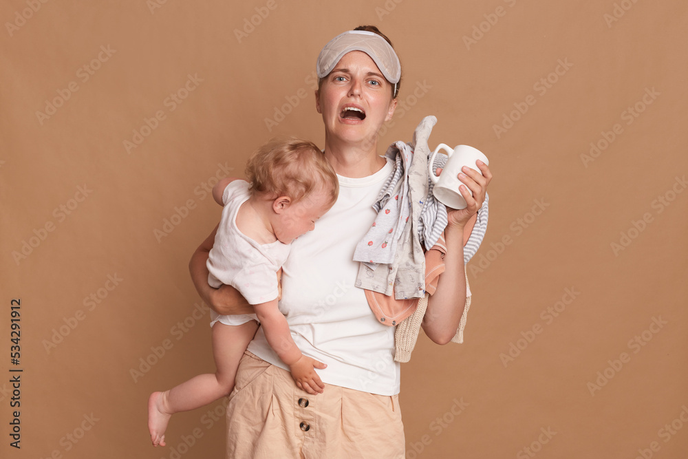 Horizontal shot of desperate sad frustrated mother with baby daughter ...