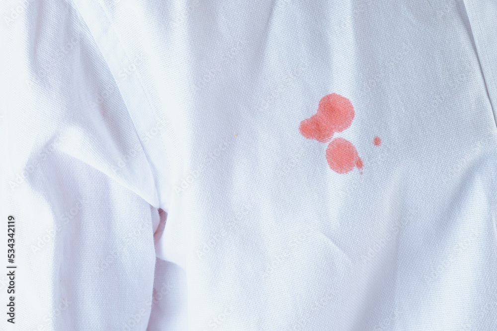 Dirty blood stain on white clothes. isolated. daily life stain concept ...
