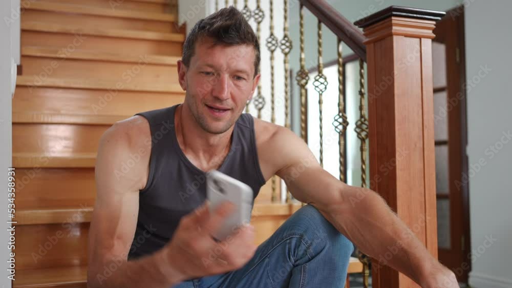 Positive Caucasian man scrolling smartphone touchscreen showing phone ...