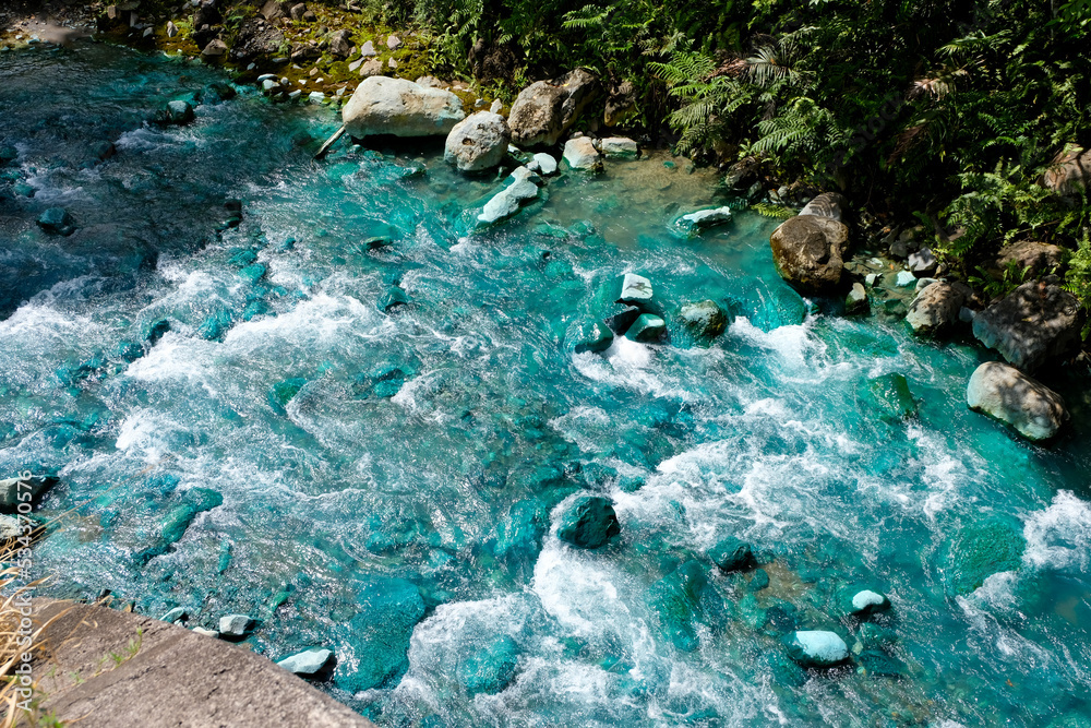 Polluted river turquoise coloured water, environmental impact at ...