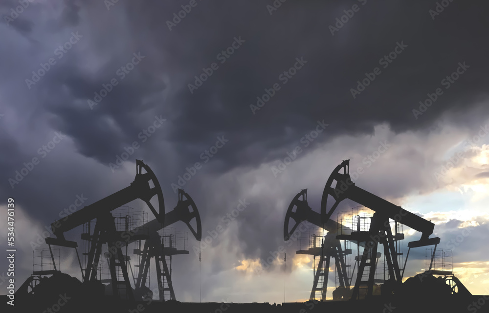 Oil drilling derricks at desert oilfield. Crude oil production from the ...