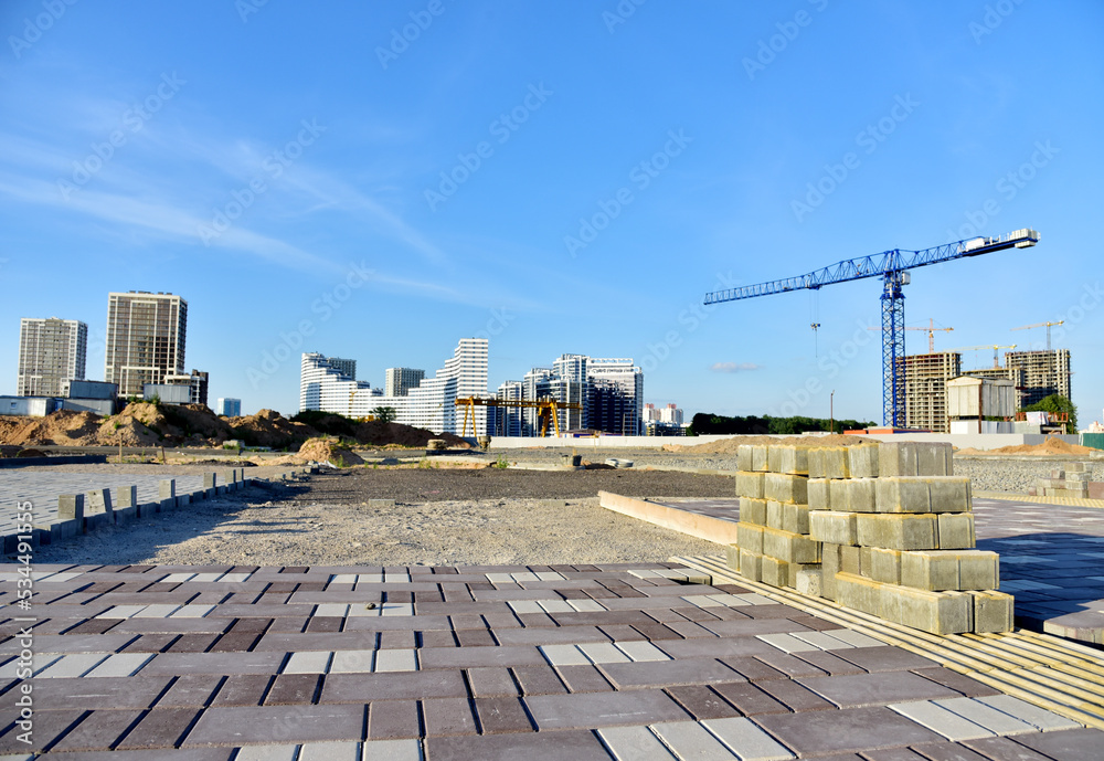 Paving bricks at construction site. Laying paving slabs and borders in ...