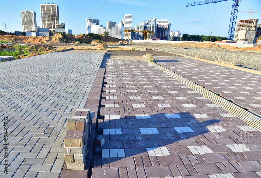 Paving bricks at construction site. Laying paving slabs and borders in ...