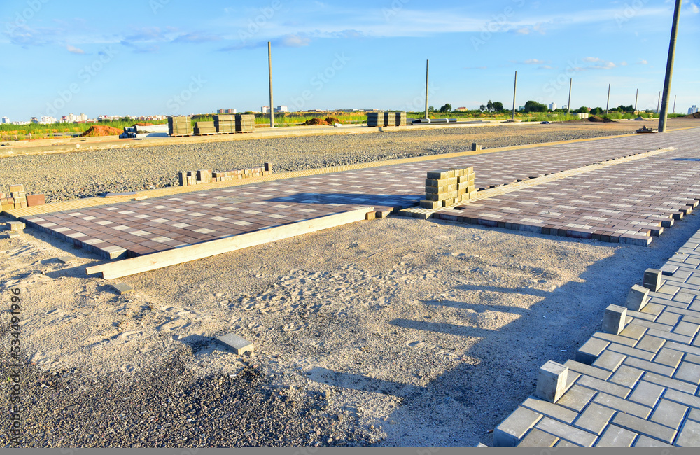Paving bricks at construction site. Laying paving slabs and borders in ...