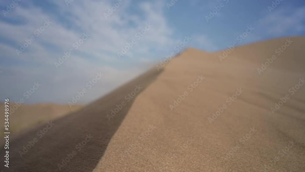 Wind in desert blowing sand and changing shape of dune; Singing Dunes ...