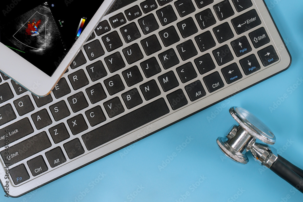 Doctor on the digital tablet checks the results echocardiography ...