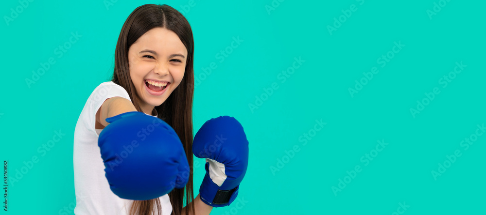 happy teen girl boxer punching in boxing gloves during sport training ...