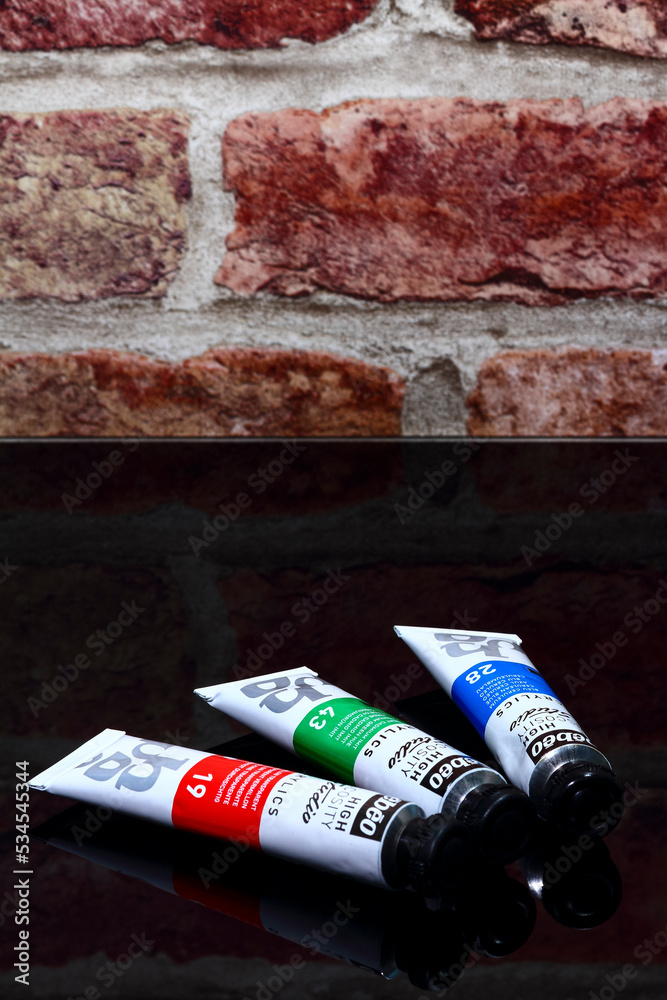 Tubes of artists acrylic paint on a glass table Stock Photo | Adobe Stock