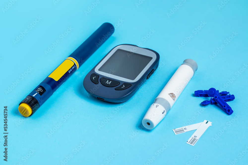 Measuring blood sugar. Glucometer, insulin pen, lancet and test strip ...