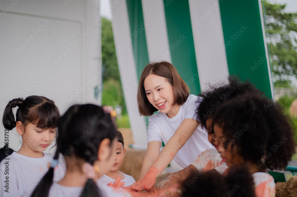 teacher and children playing color in Art join hand in hand fun ...