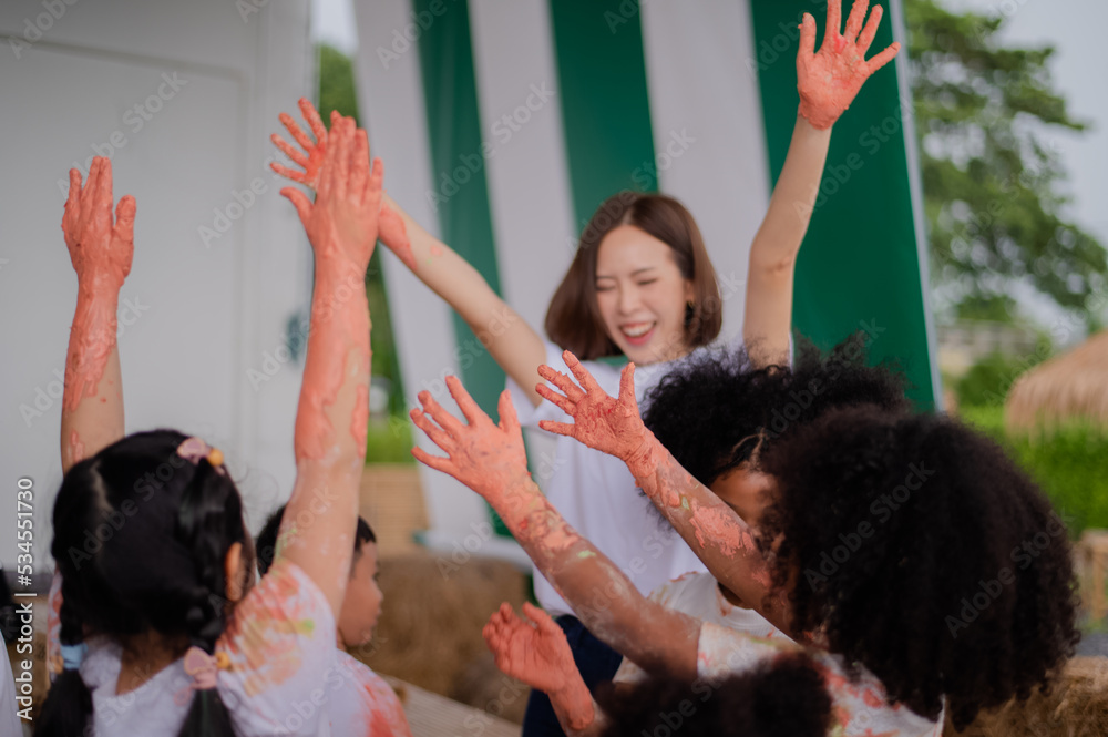 teacher and children playing color in Art join hand in hand fun ...