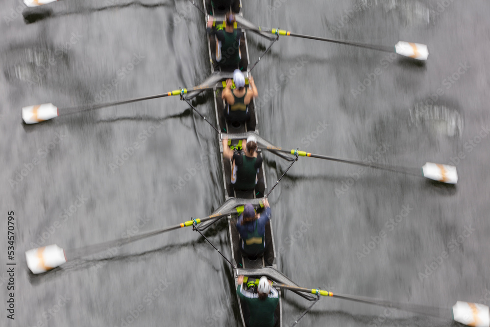 Overhead view of female crew racers rowing in an octuple racing shell ...