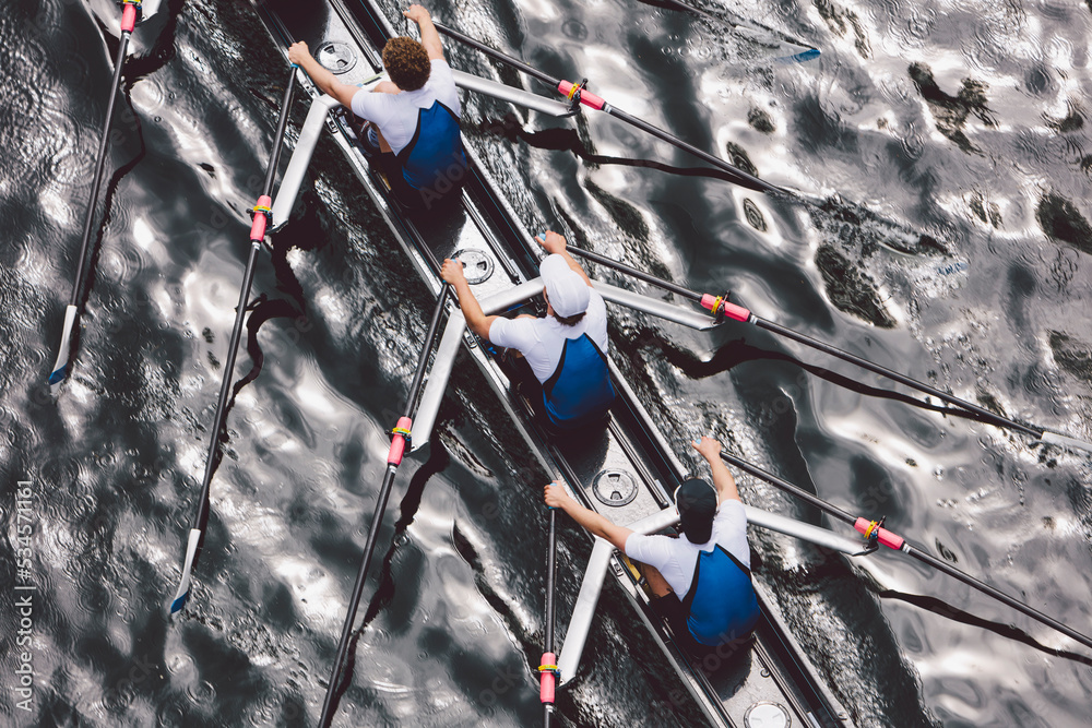 Overhead view of a crew rowing in an octuple racing shell boat, rowers ...
