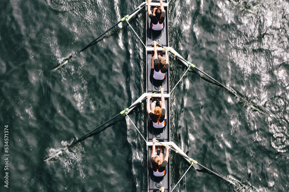 Overhead view of female crew racers rowing in an octuple racing shell ...