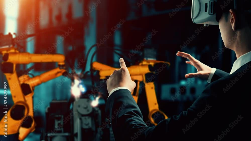 Engineer use cybernated robotic software to control industry robot arm ...