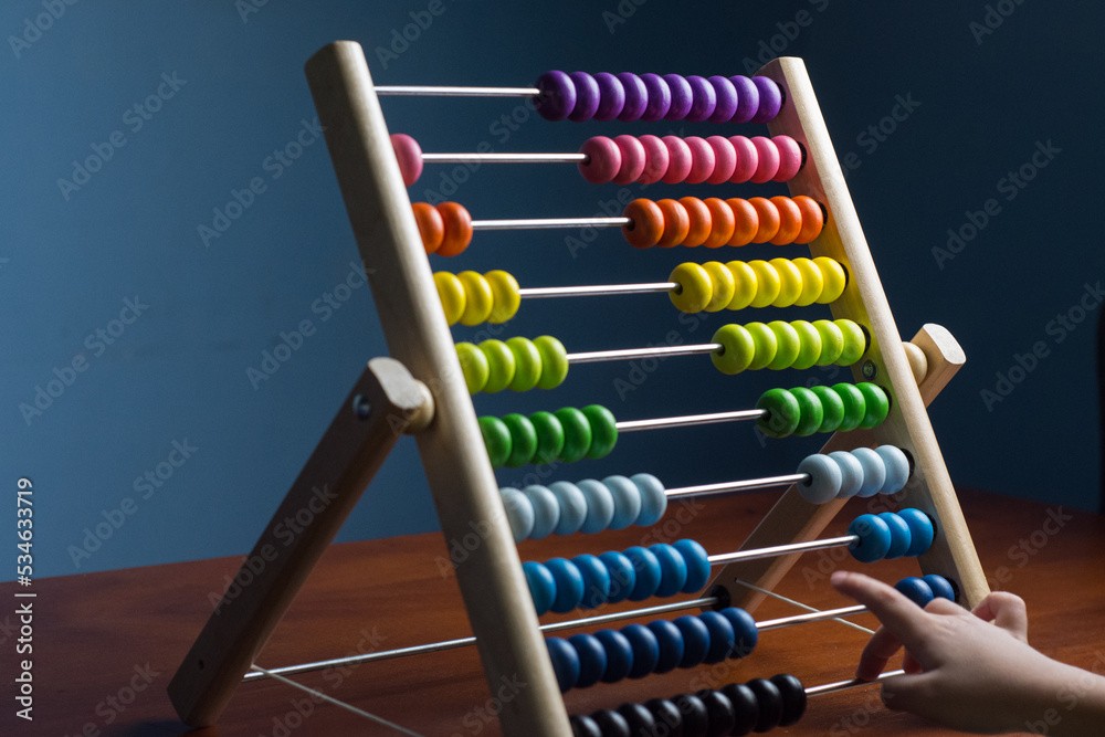 Abacus with colorful beads on blue background, close up, Counts kids ...