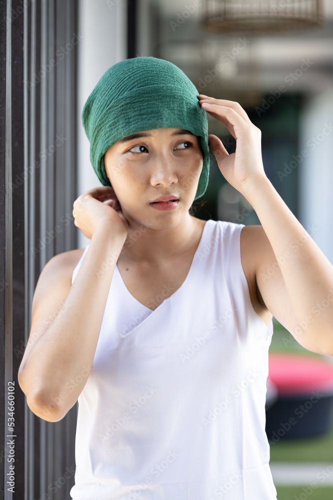 Sad and depressed asian woman cancer patient suffering from alopecia ...